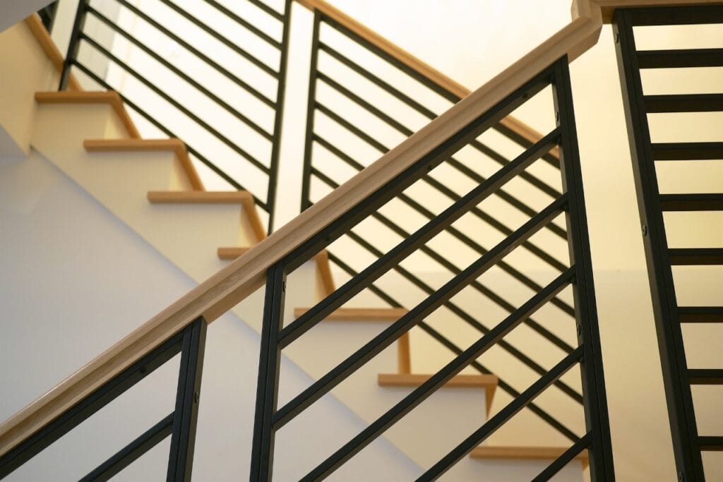 Basement Stairway Combines Wood and Metal for Appealing Transitional ...